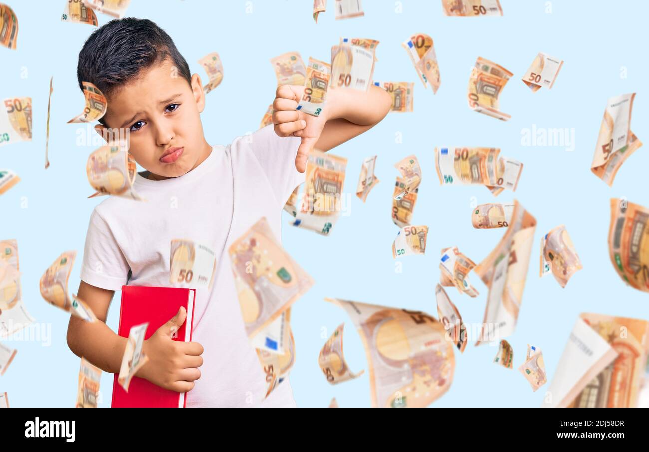 Little cute boy kid reading a book with angry face, negative sign ...