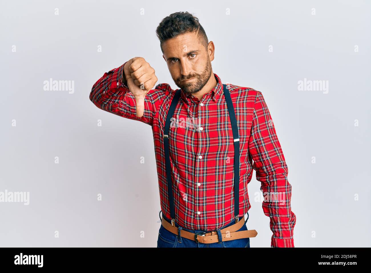Handsome man with beard wearing hipster elegant look looking unhappy ...