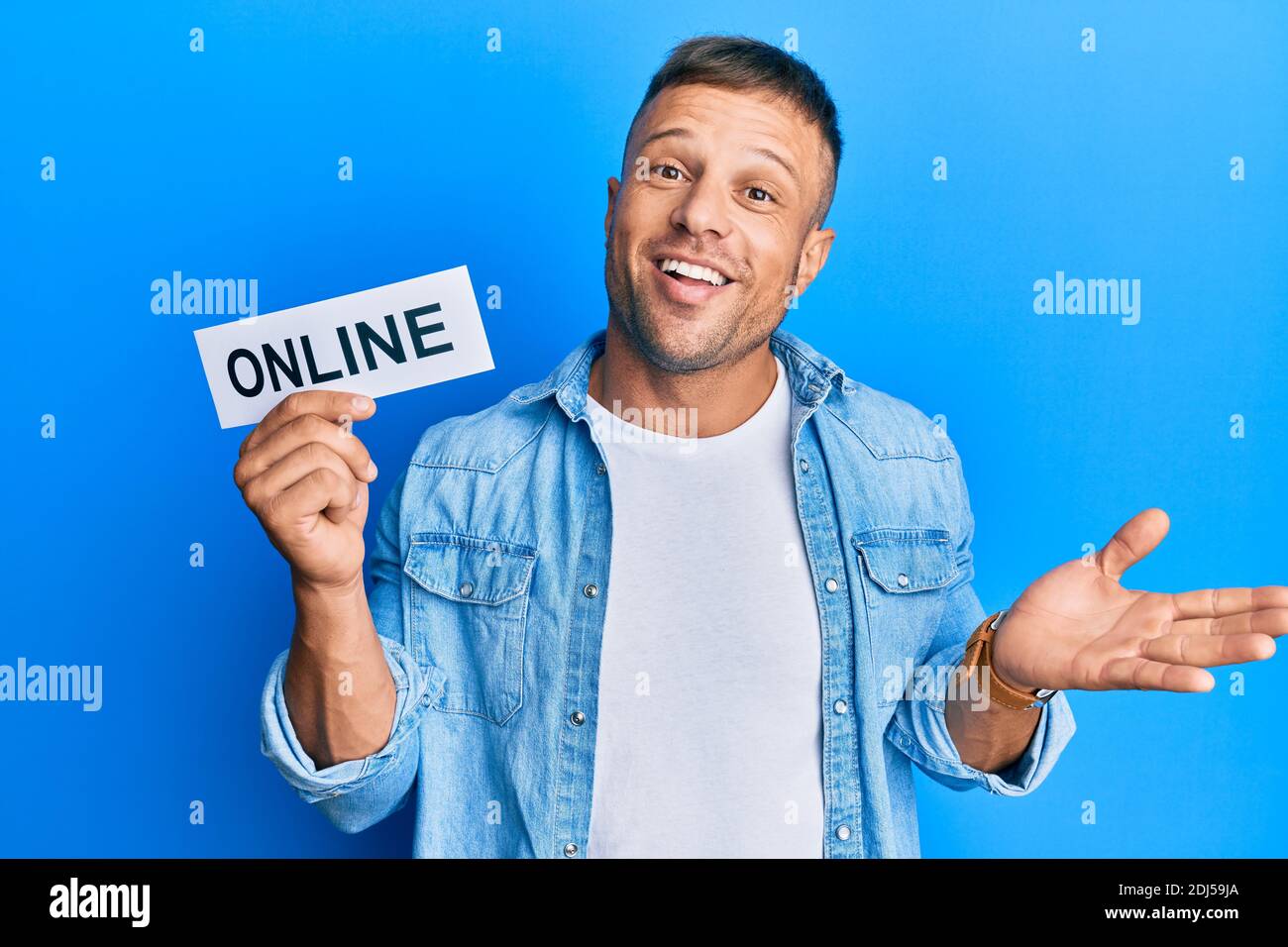 Handsome muscle man holding online word on paper celebrating ...