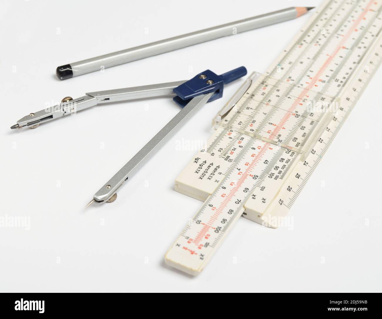 Logarithmic ruler, compasses, pencil on a white background . Stationery ...
