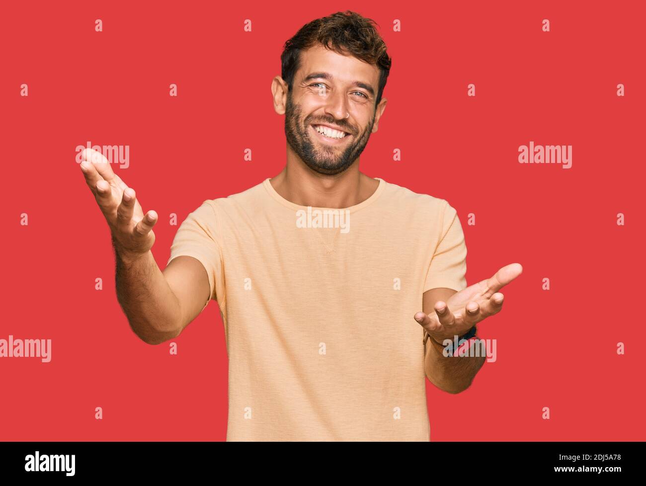 Handsome young man with beard wearing casual tshirt smiling cheerful ...