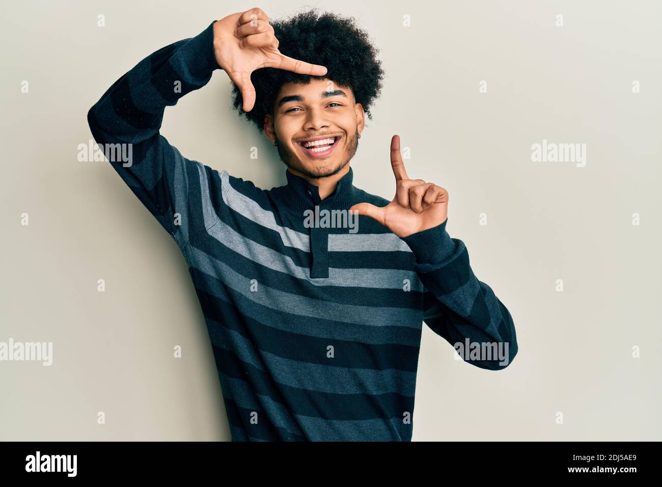 Young african american man with afro hair wearing casual clothes ...