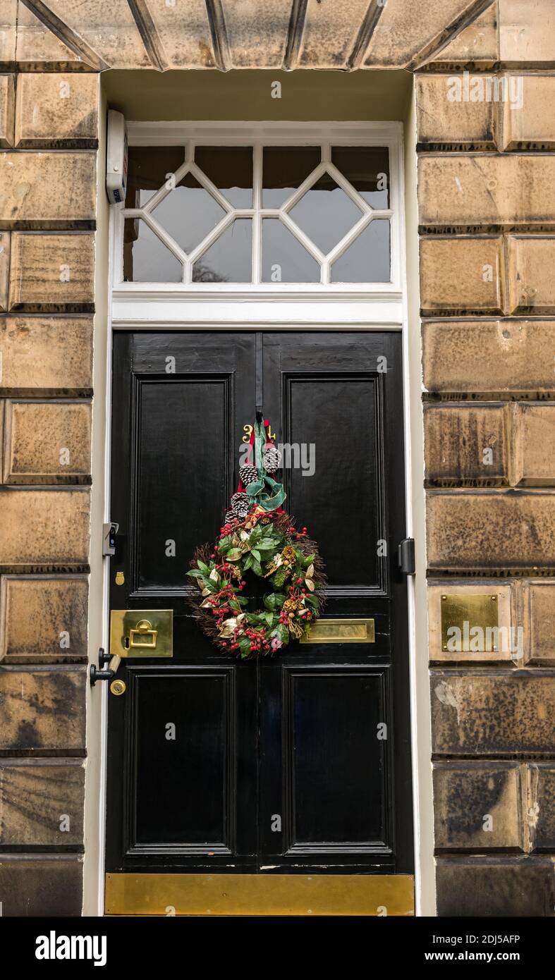 Decorative Christmas wreath on panelled front door of Georgian ...