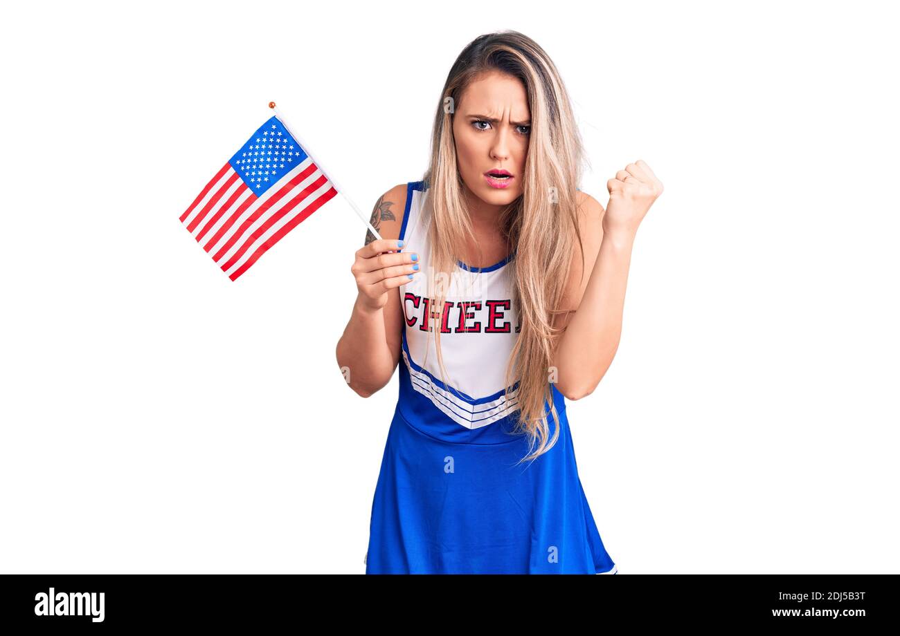Young beautiful blonde woman wearing cheerleader uniform holding united ...