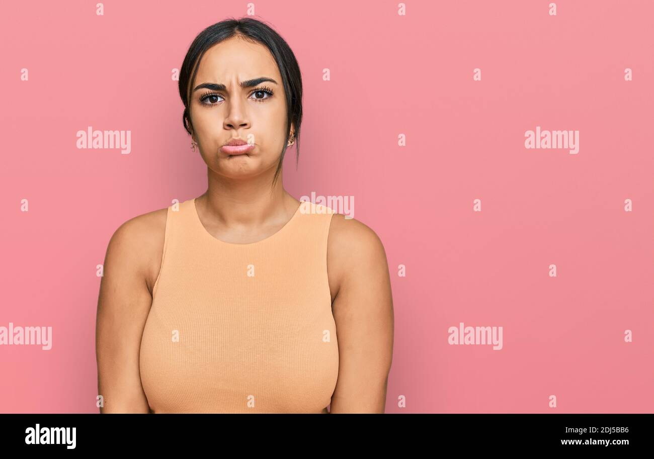 Young brunette woman wearing casual clothes depressed and worry for ...