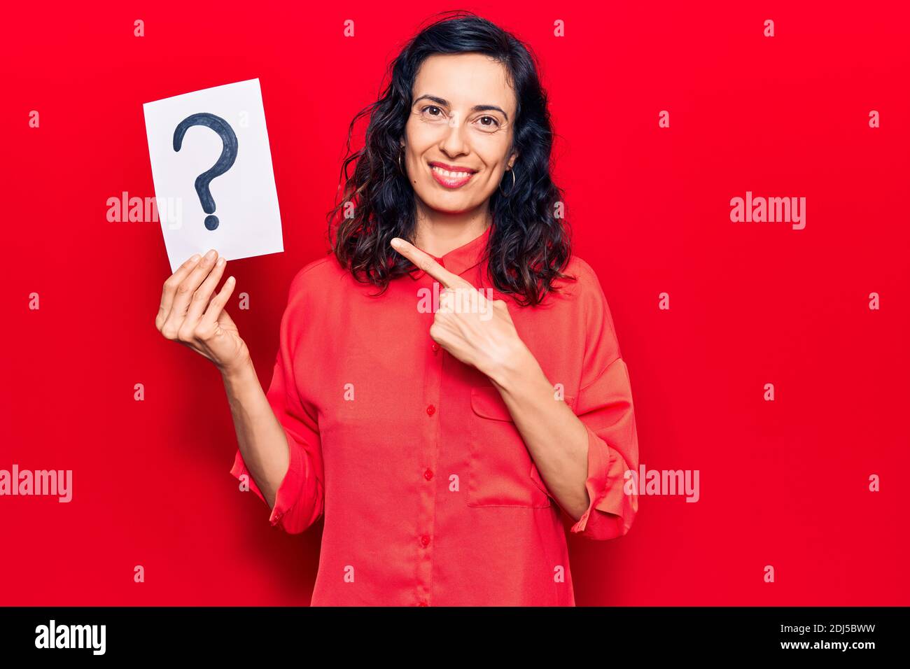 Young beautiful hispanic woman holding question mark smiling happy ...