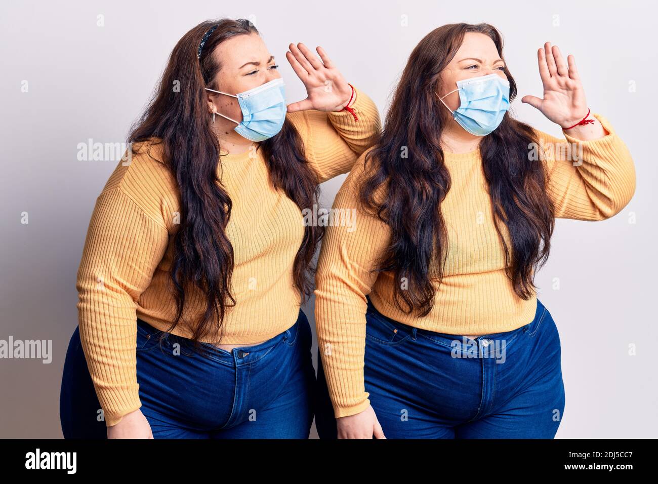 Young plus size twins wearing medical mask shouting and screaming loud ...