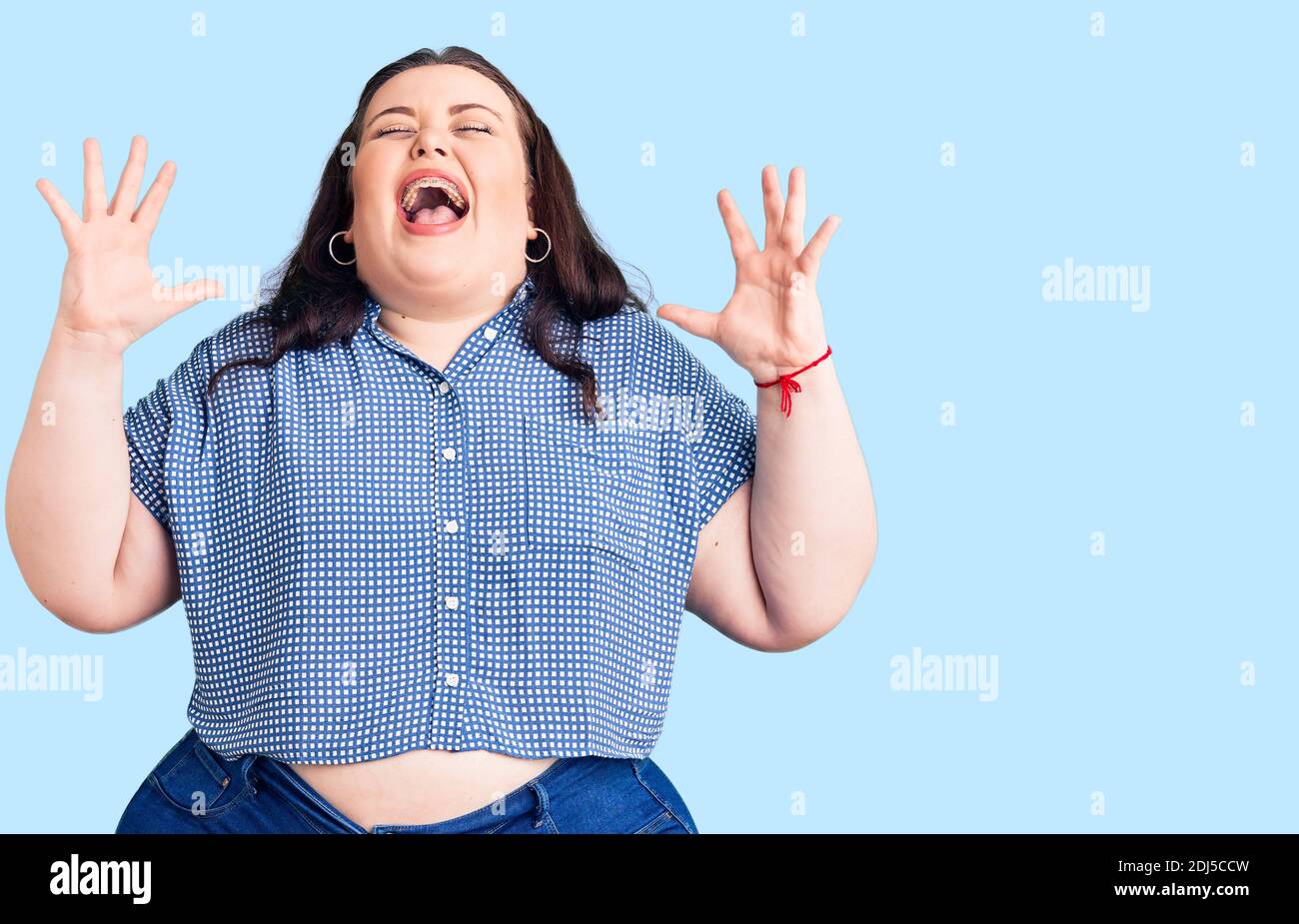 Young plus size woman wearing casual clothes celebrating mad and crazy ...
