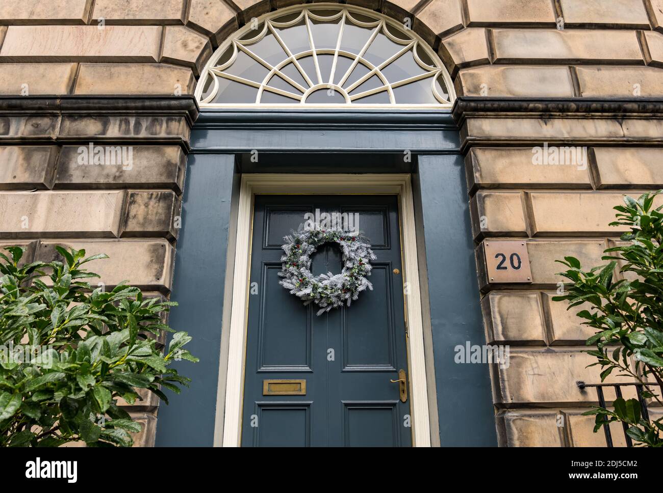Decorative Christmas wreath on panelled front door number 20 of ...