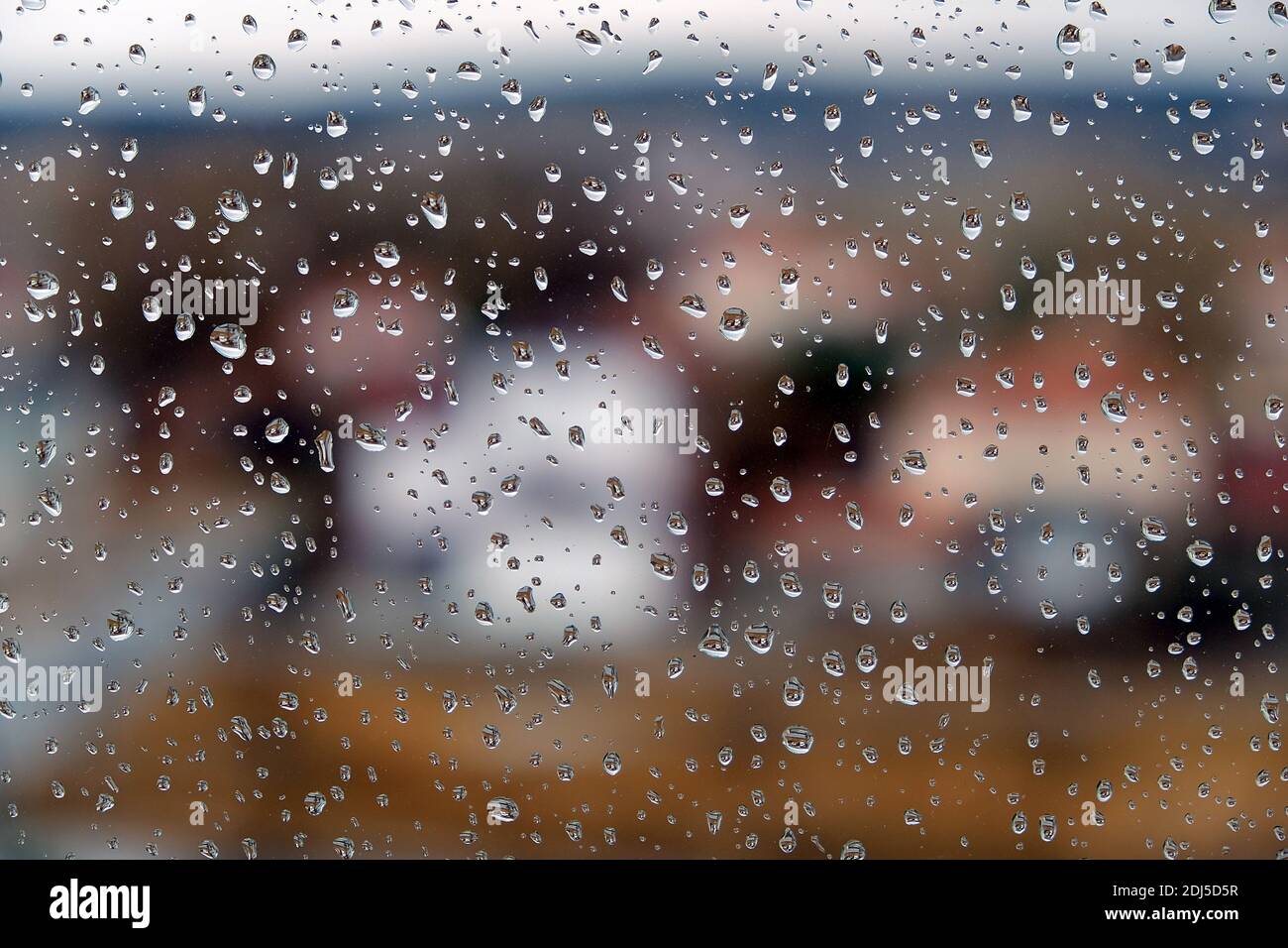 water droplets on glass and view of the landscape, droplets on close-up ...