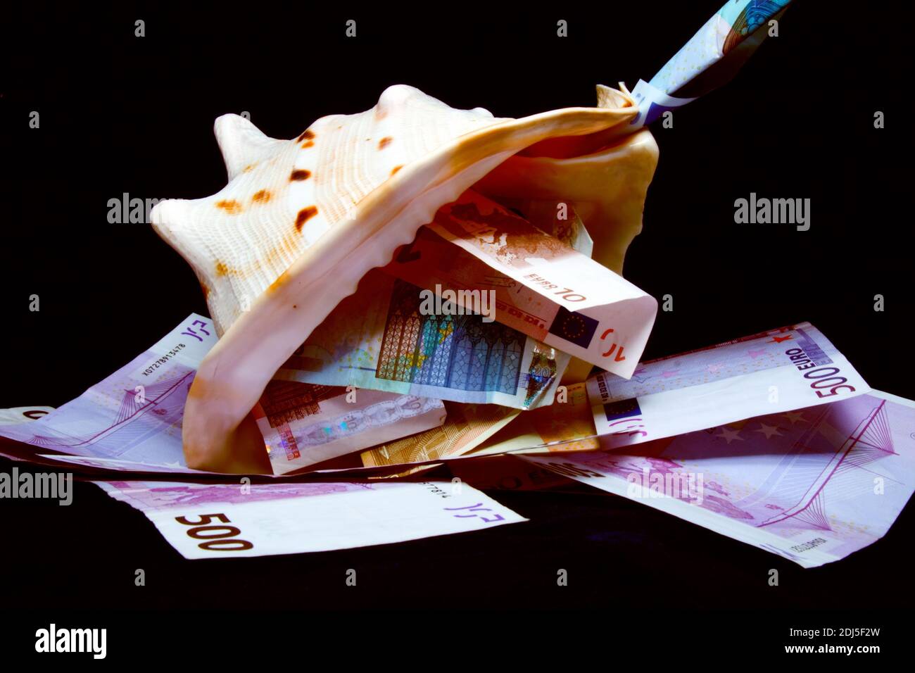 on a black background are Euro banknotes of different denominations in ...