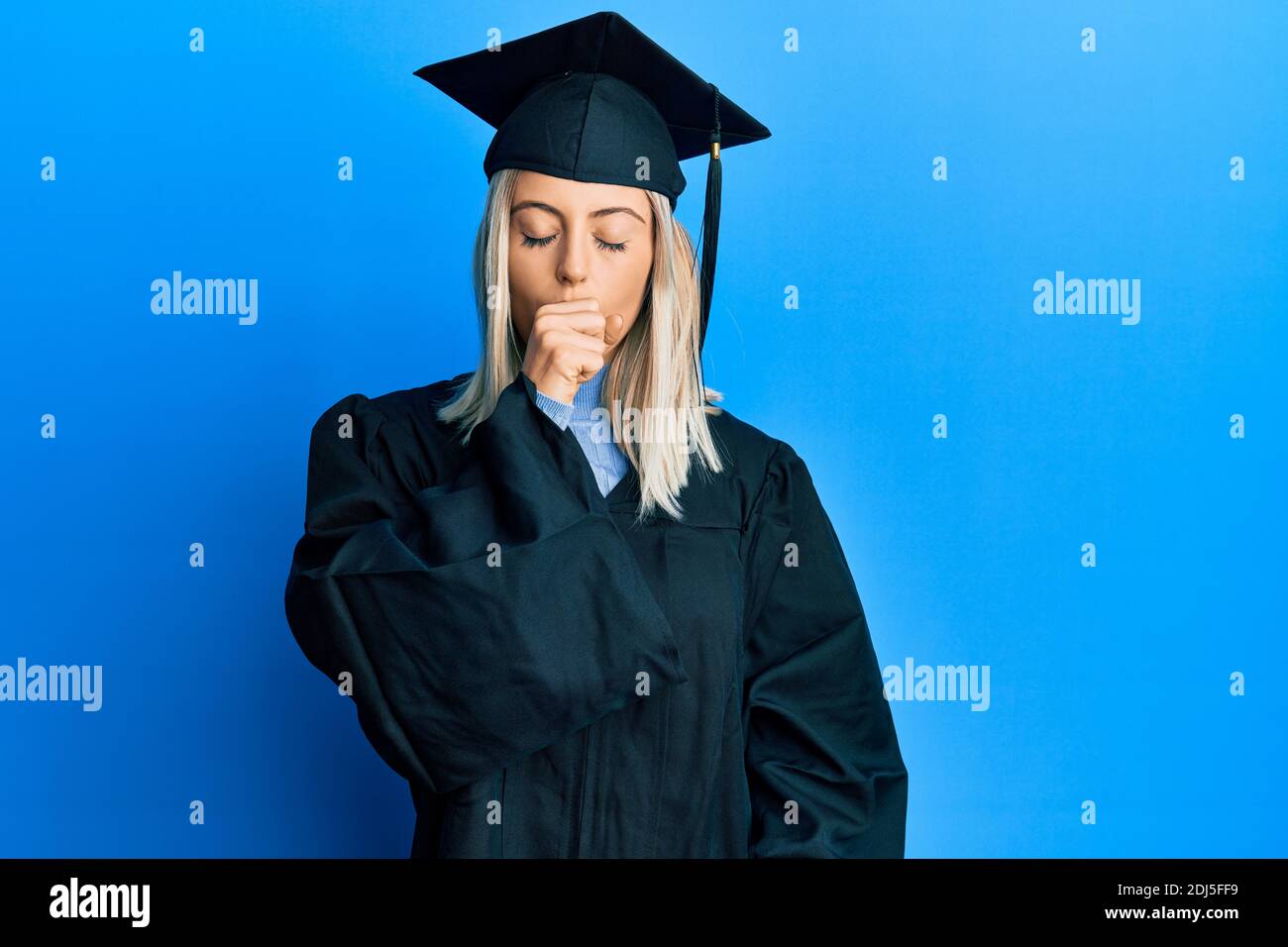 Beautiful blonde woman wearing graduation cap and ceremony robe feeling ...