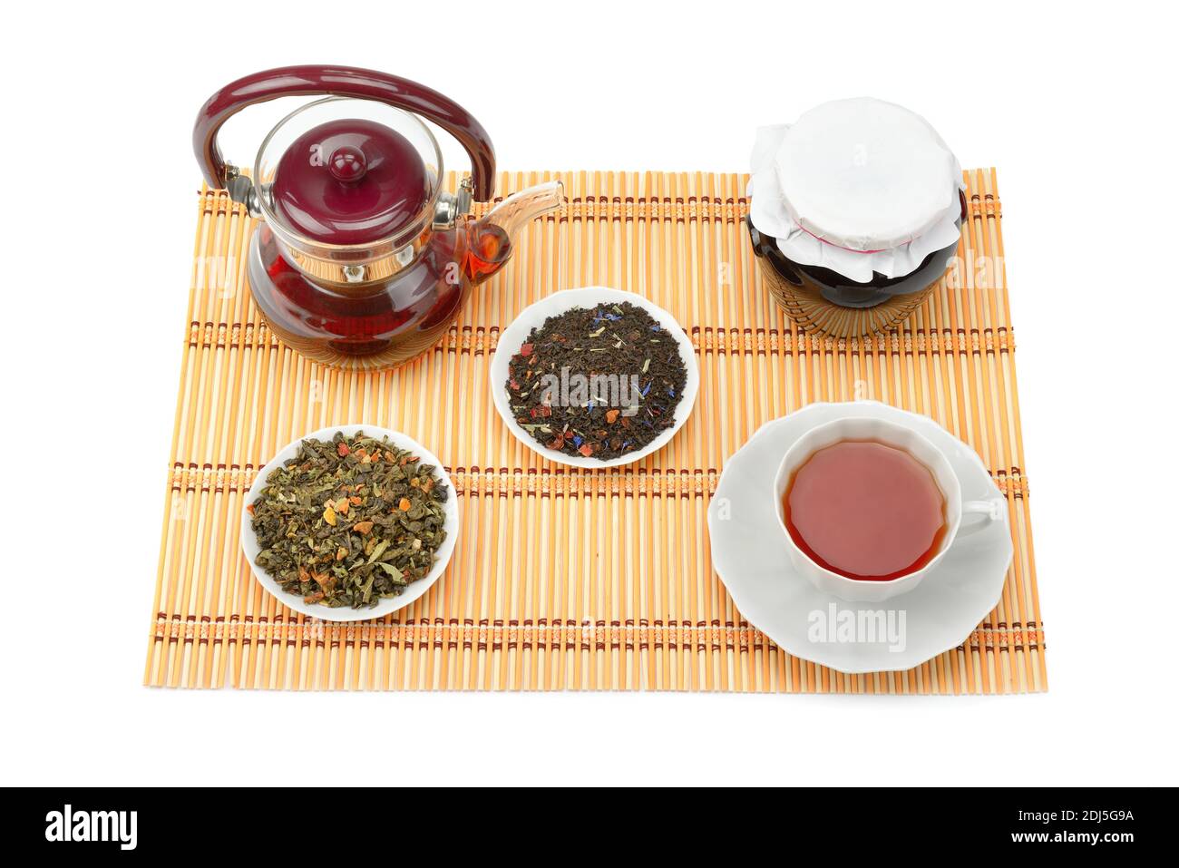 Teapot, cup of tea, jam jar and tea leaves isolated on white background ...
