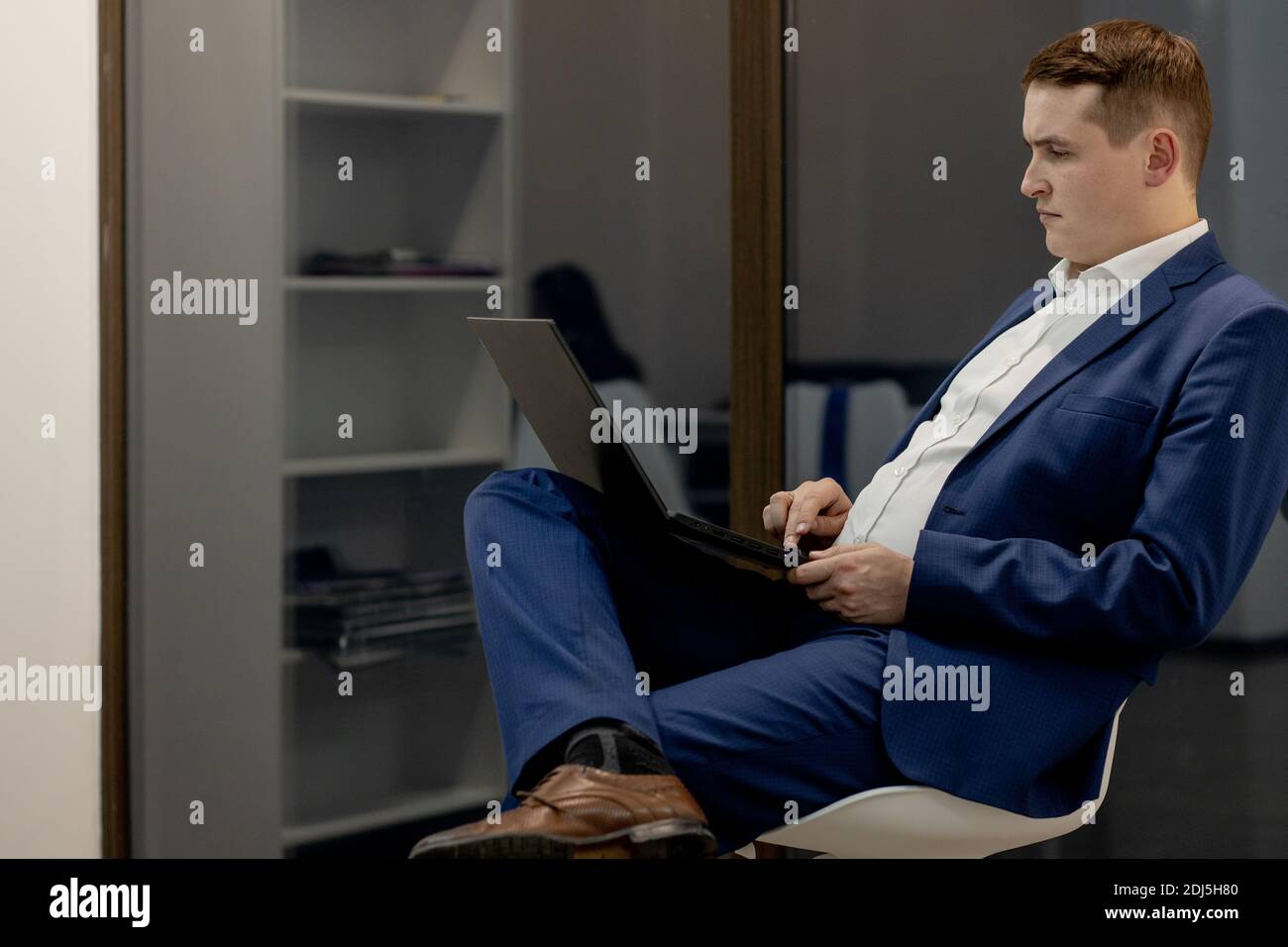 Typical working day. Close up of a confident young businessman sitting ...