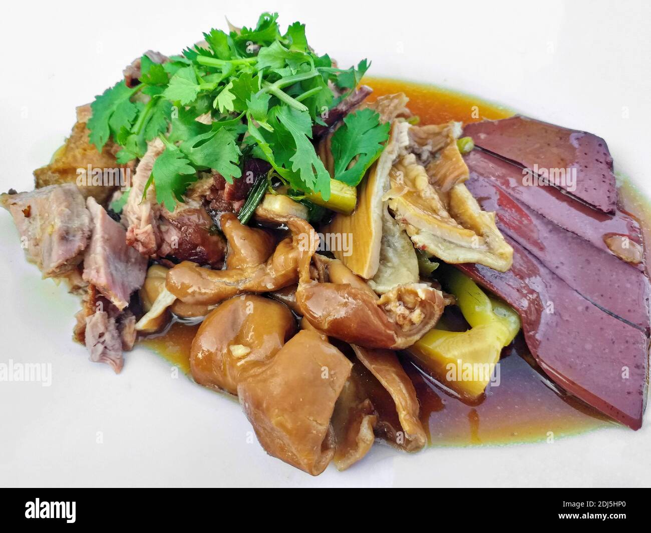 A closeup shot of stewed pork intestine isolated on white background ...