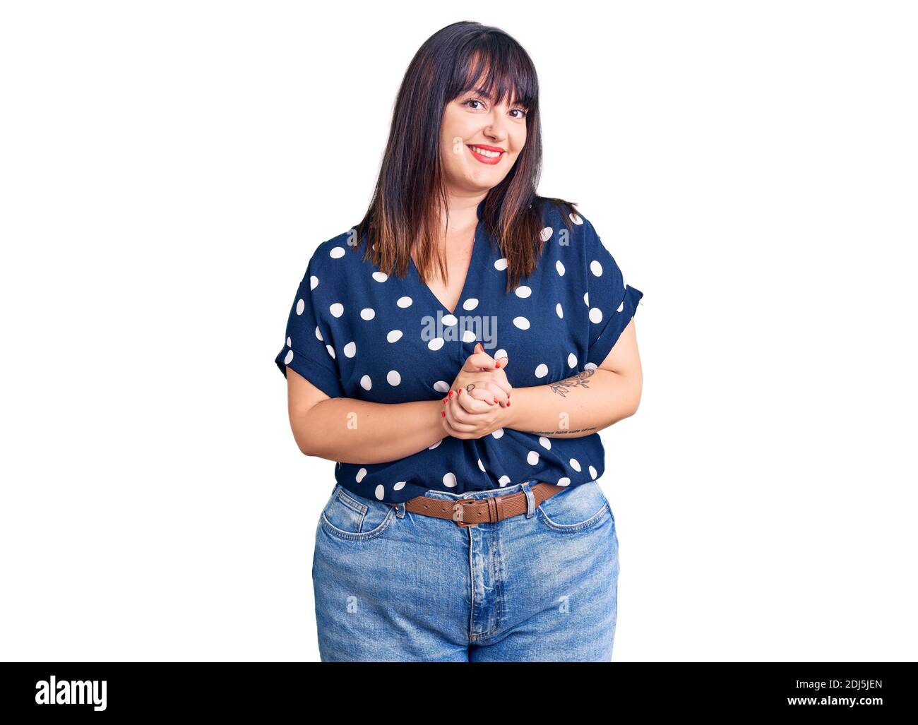 Young plus size woman wearing casual clothes with hands together and ...