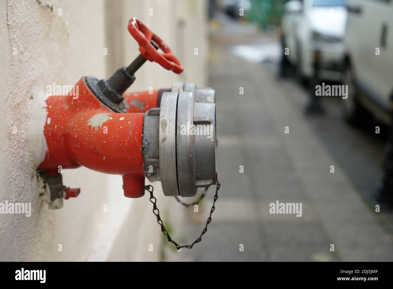 A Dark Red Fire Hydrant Sits Inside An Old Wall Stock Photo - Alamy