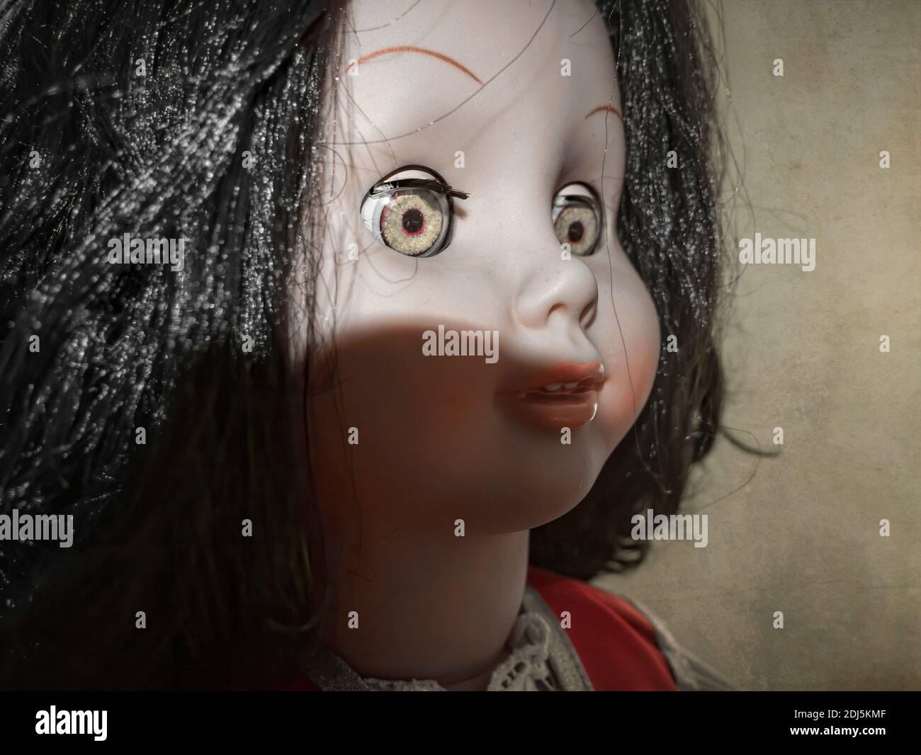 Creepy scary old vintage doll face with black hair smiling Stock Photo ...