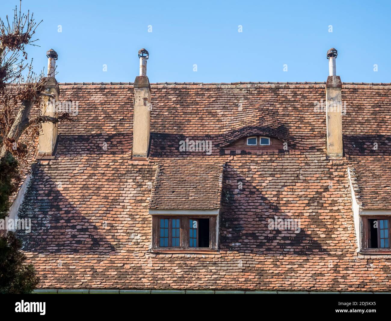 Old medieval house with red brick roof tiles in Sighisoara, Romania ...