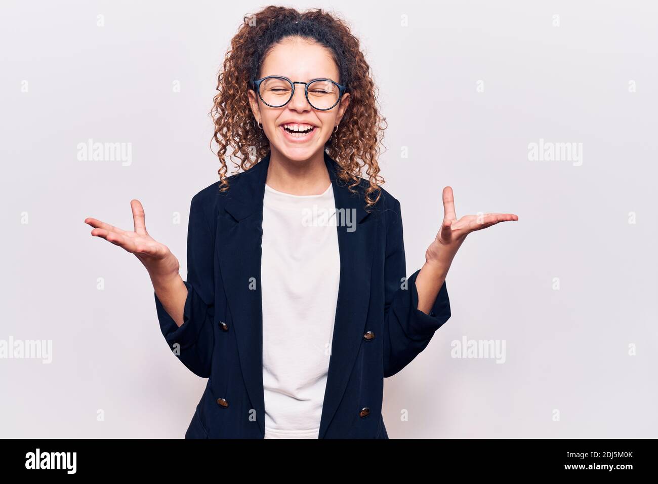 Beautiful kid girl with curly hair wearing business clothes and glasses ...