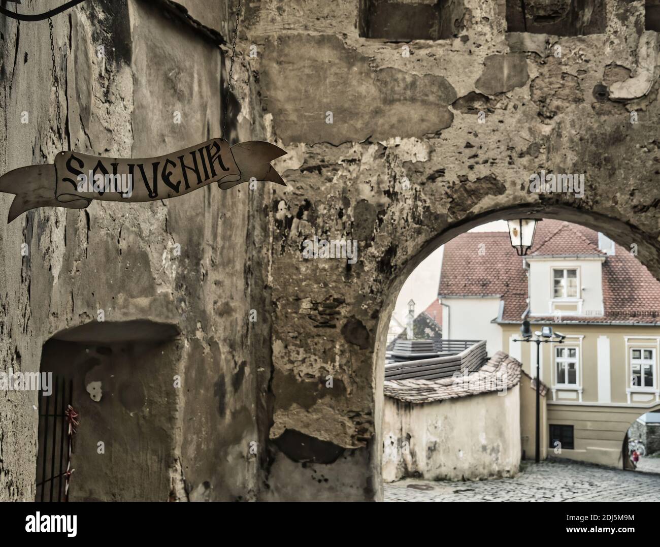 Souvenir shop sign hanging from the stone wall in Sighisoara medieval ...