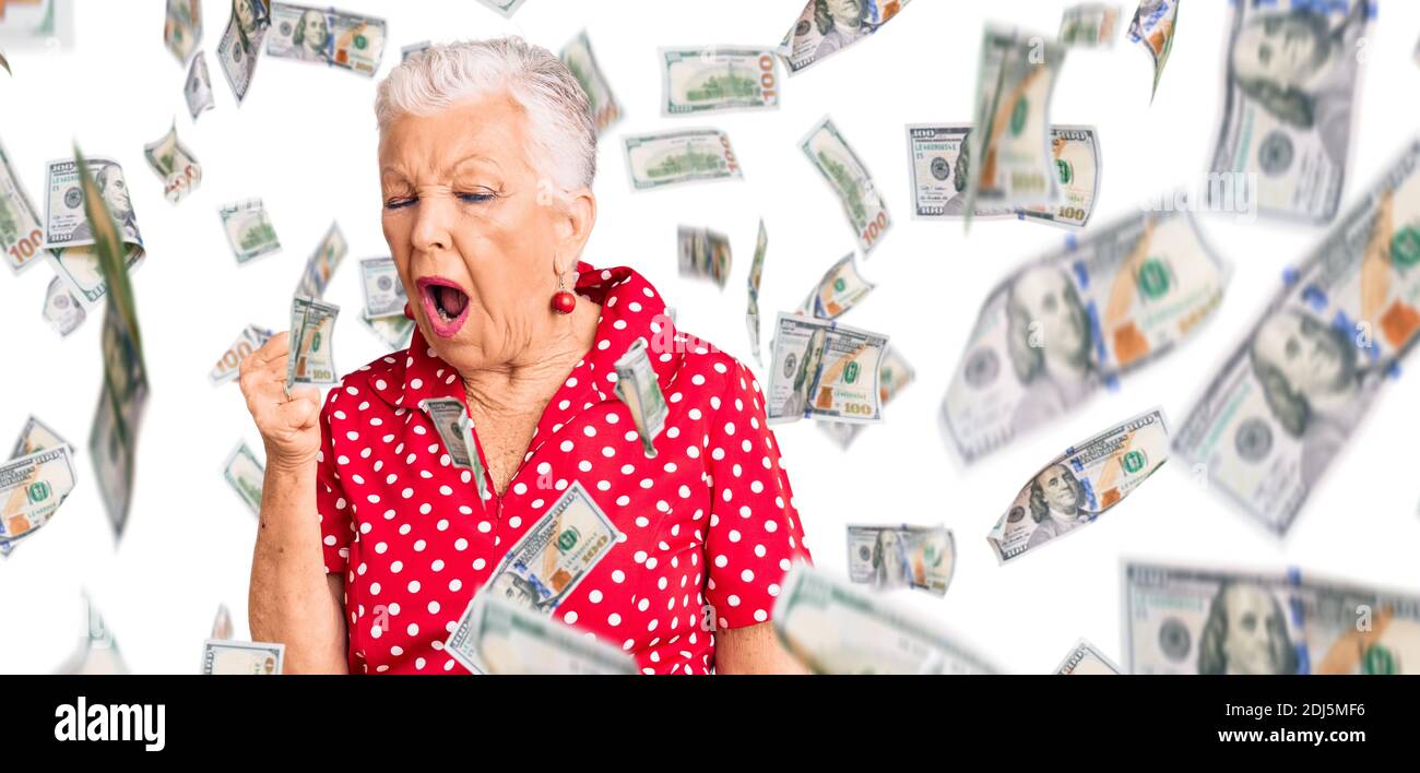 Senior beautiful woman with blue eyes and grey hair wearing a red ...