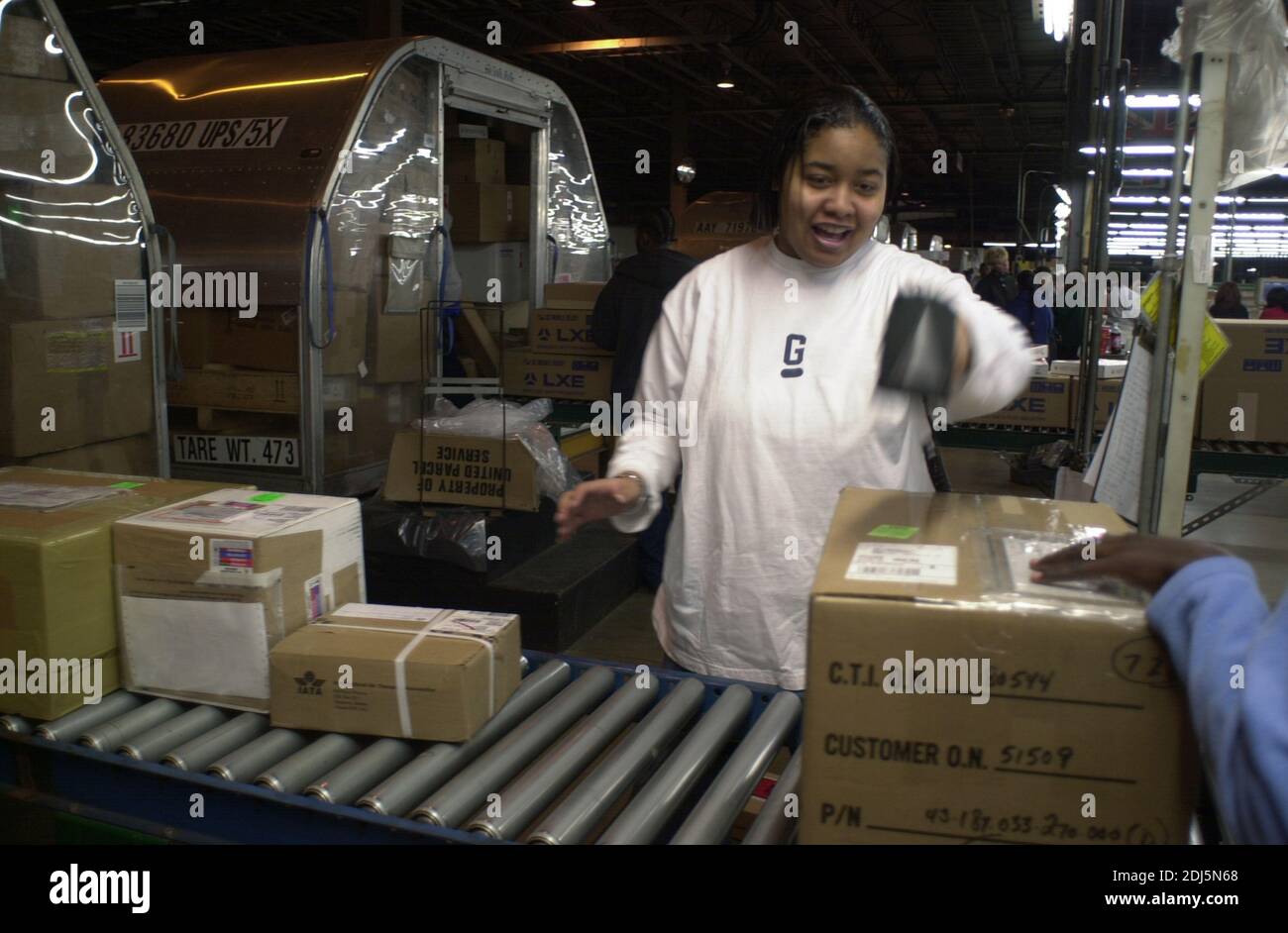 United Parcel Servce employees sort through packages to be shipped ...