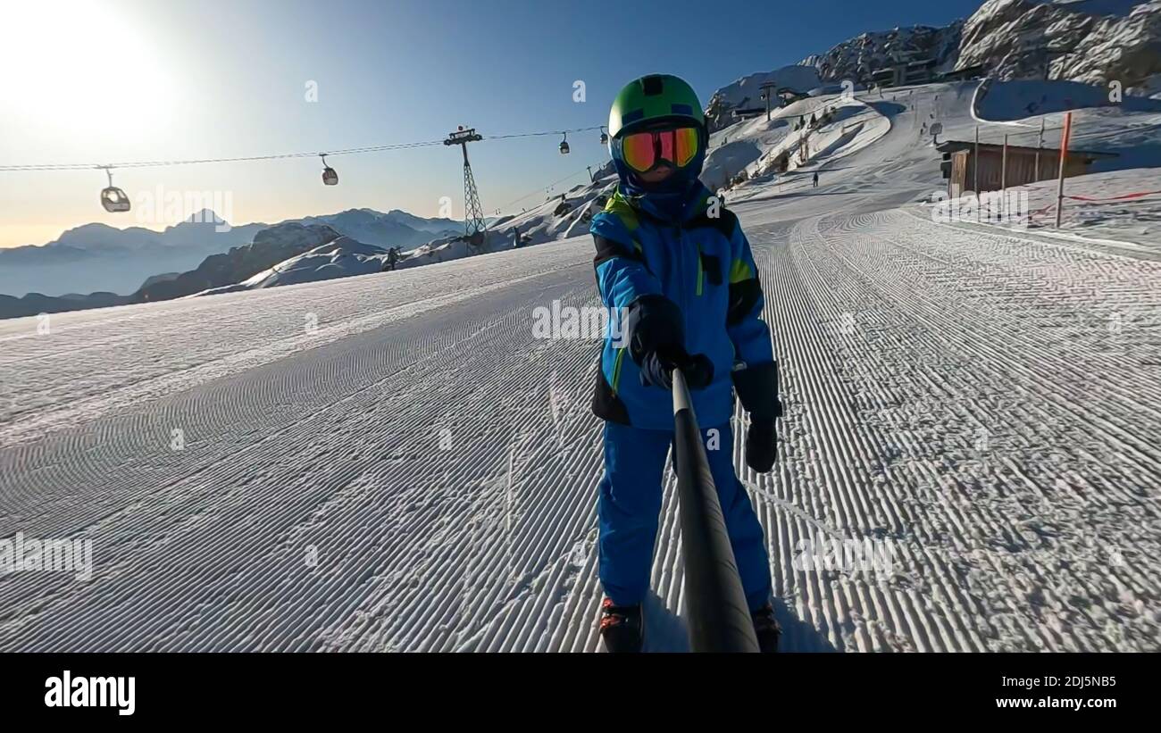 Little boy skiing. A 6 year old child enjoys a winter holiday in the ...