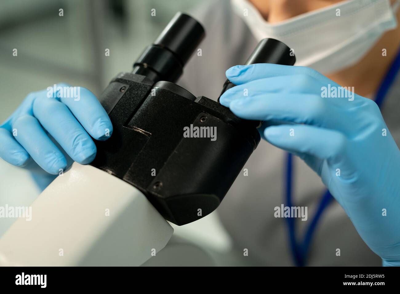 Gloved hands of clinician or worker of scientific laboratory holding by ...