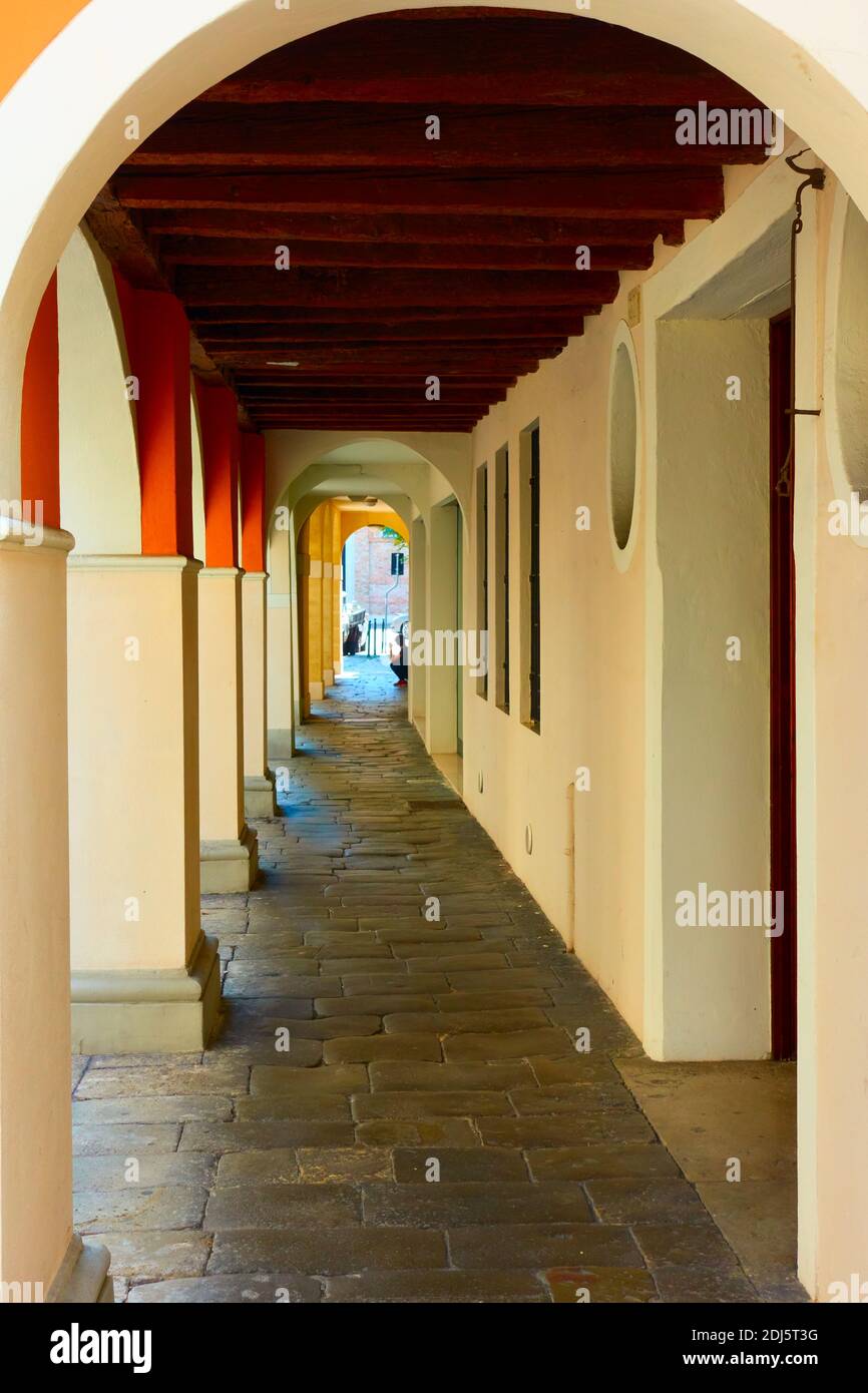 Perspective of covered passageway along a street in Treviso, Italy ...