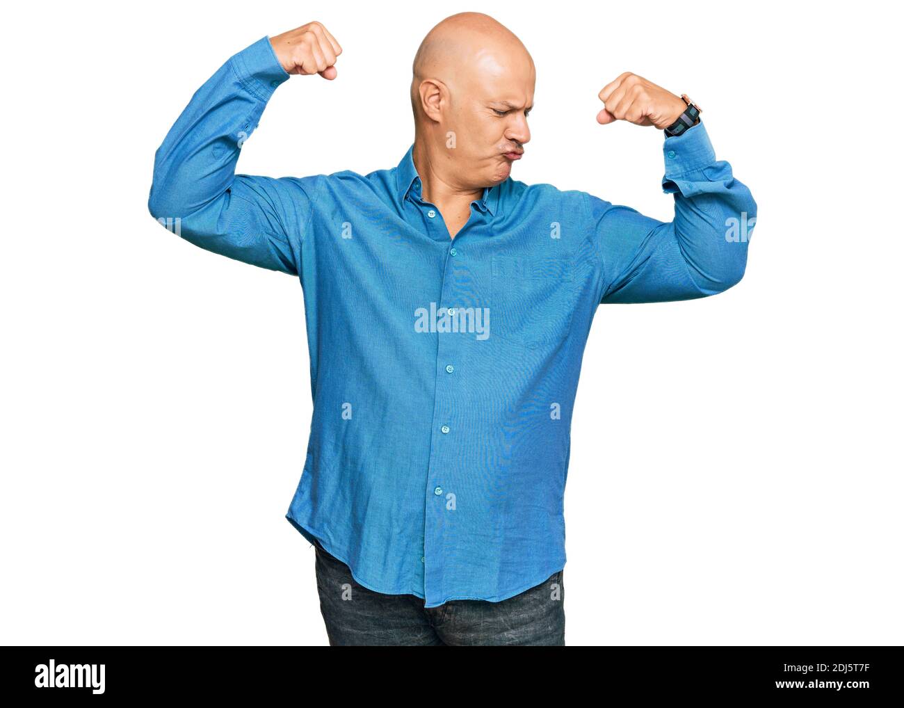 Middle age bald man wearing casual clothes showing arms muscles smiling ...
