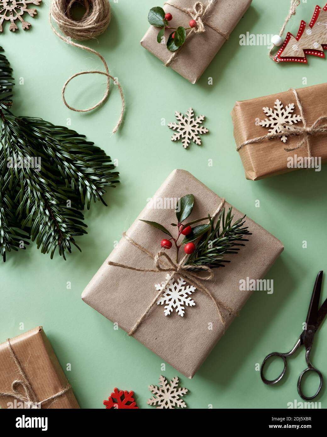 Christmas presents wrapped in ecological recycled paper with wooden ...