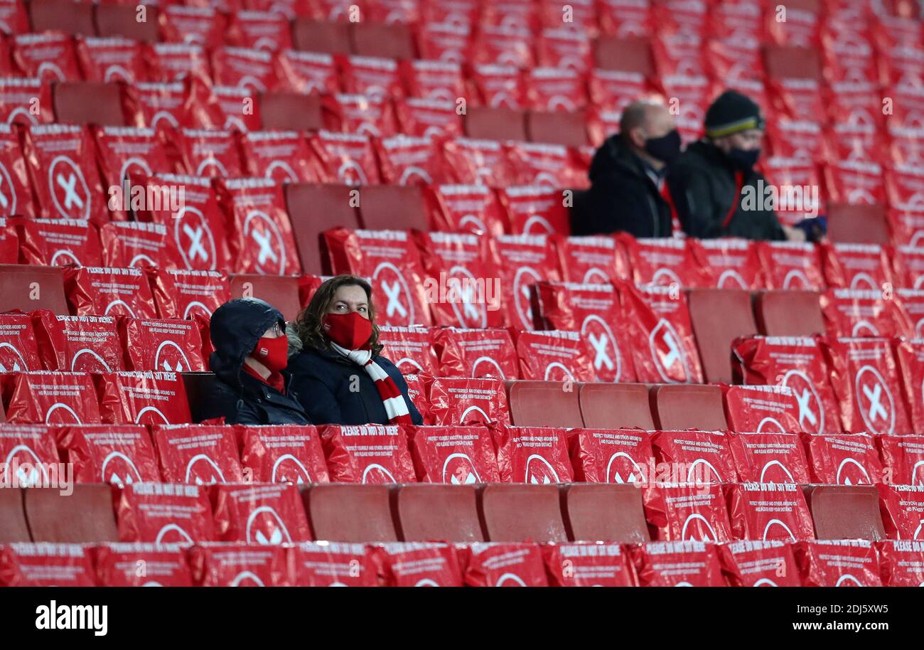 Arsenal fans take their socially distanced seats in the stands for the ...