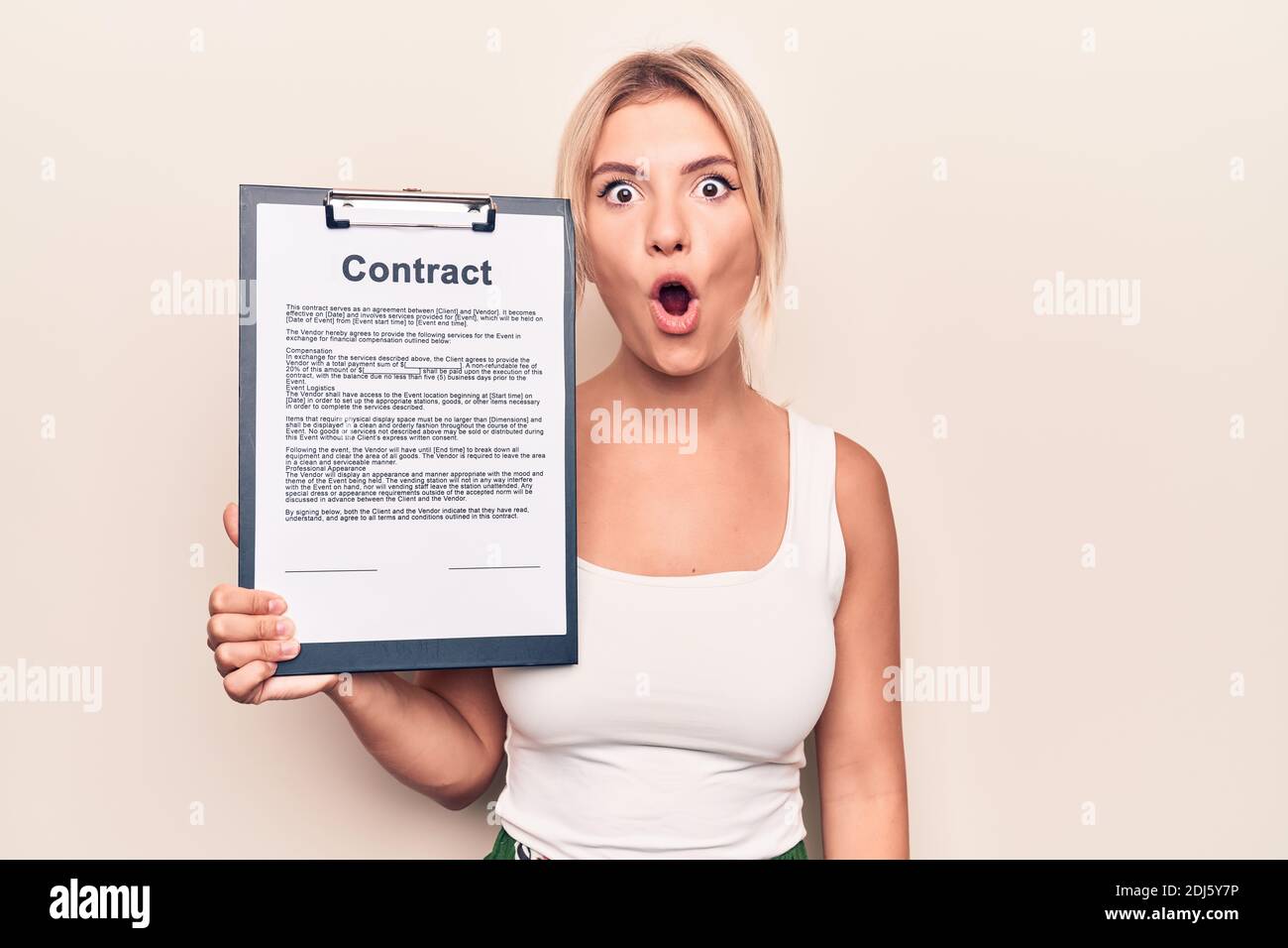 Beautiful blonde woman holding clipboard with contract document paper ...