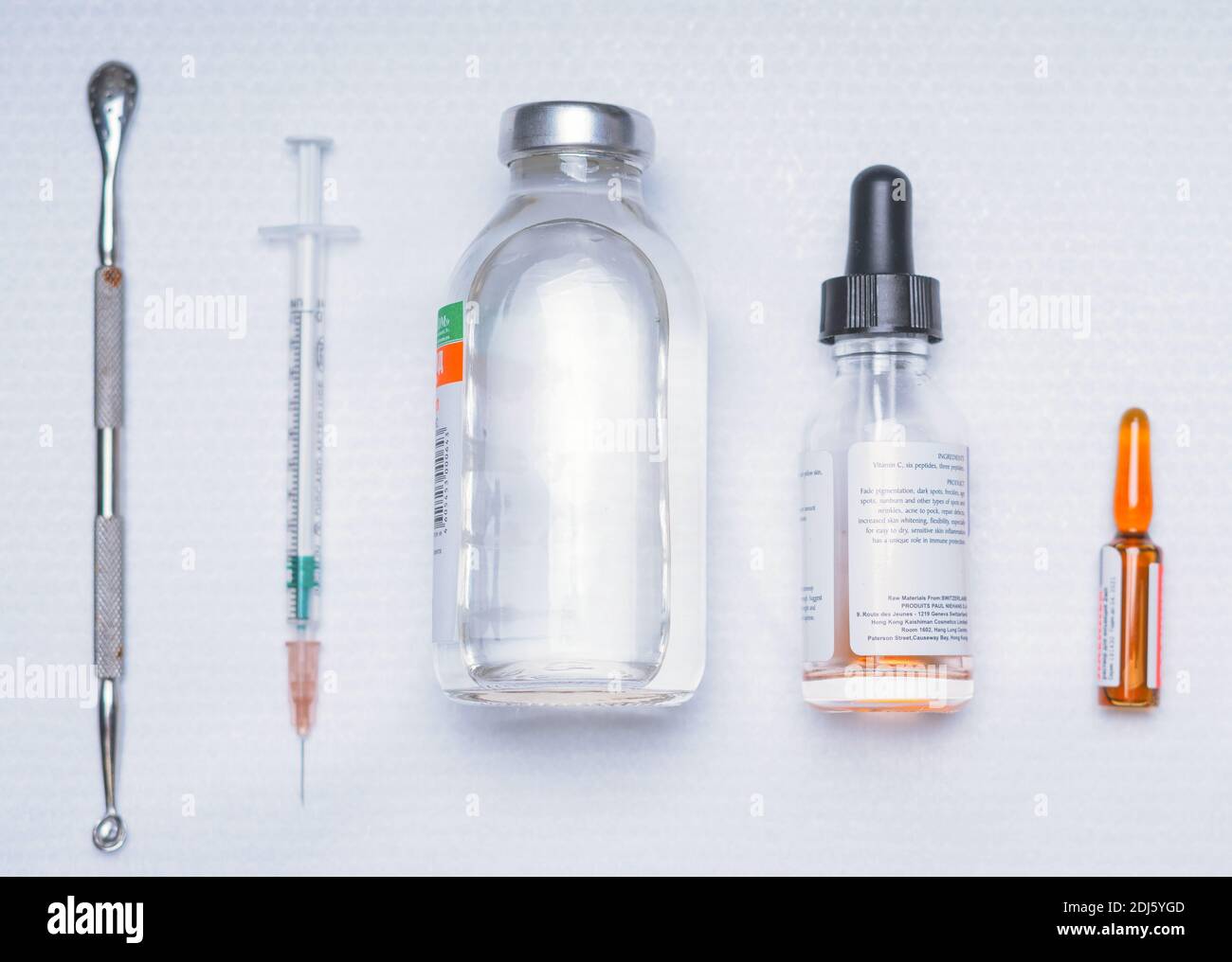 Medical ampoules and syringe on light backgroung, medicine concept ...