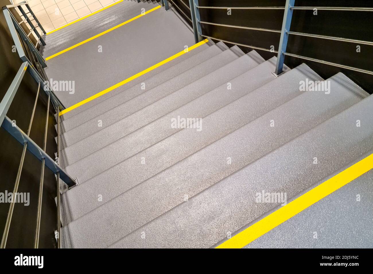 yellow warning sign on stairs signifying a potential hazard, steep ...