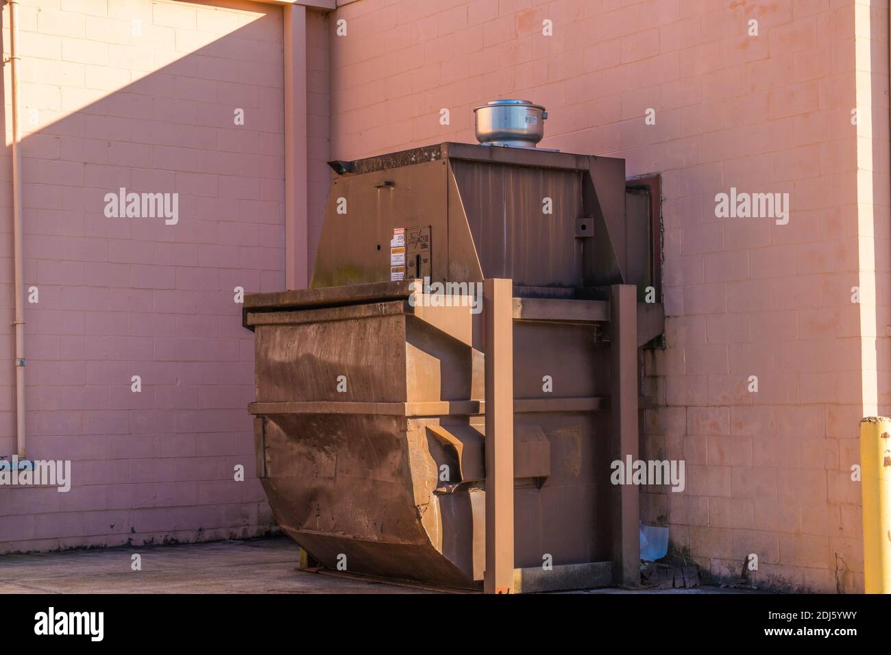 Augusta, Ga USA - 11 04 20: Small trash compactor and cardboard behind ...