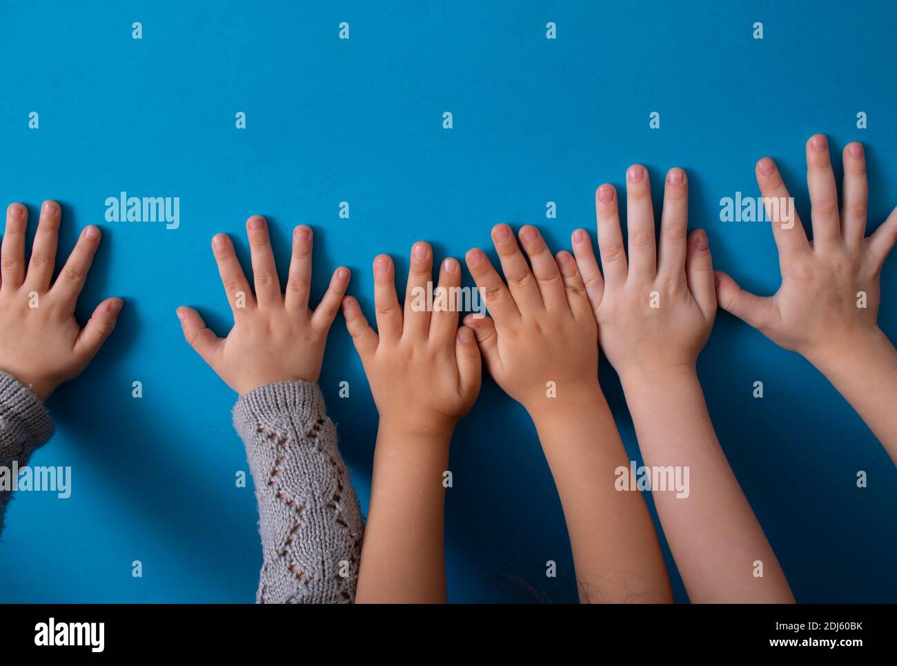 Sisters and brothers holding hands together, flat lay Stock Photo - Alamy
