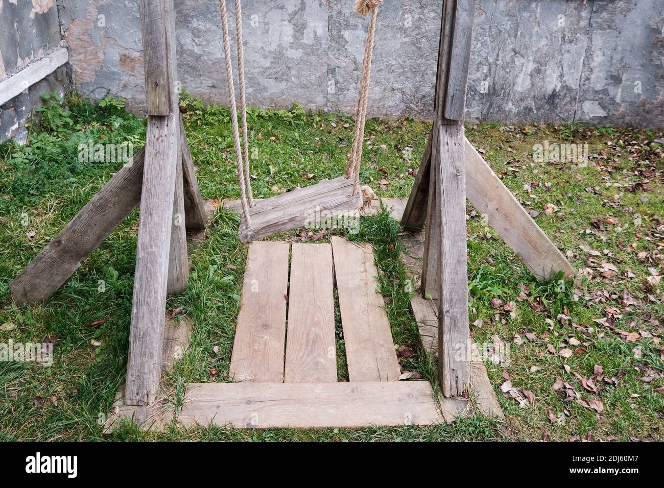 The old wooden swing on the ropes, the courtyard house Stock Photo - Alamy