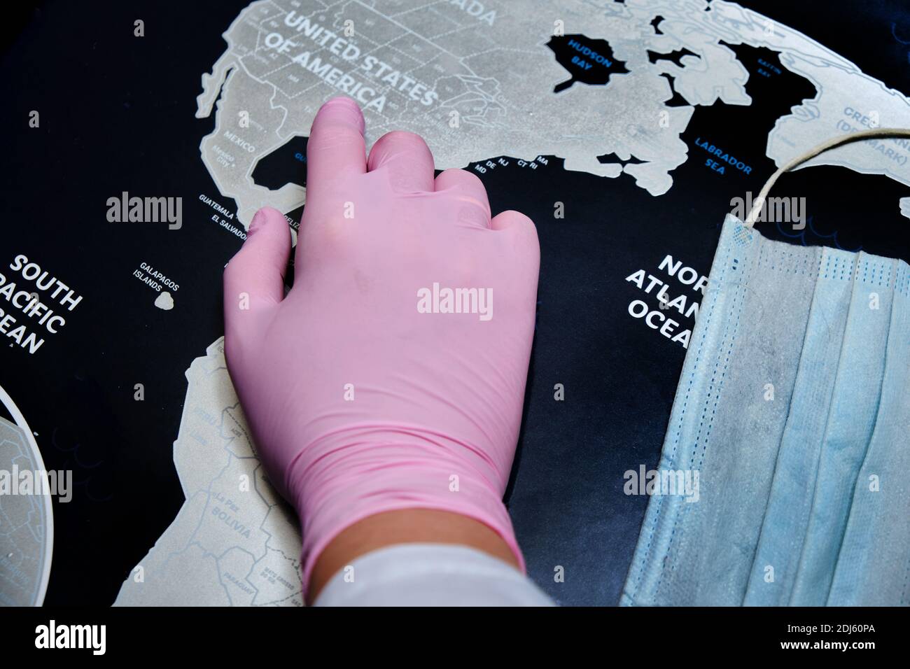 The nurse's hand points to the United States on the world map. Medical ...
