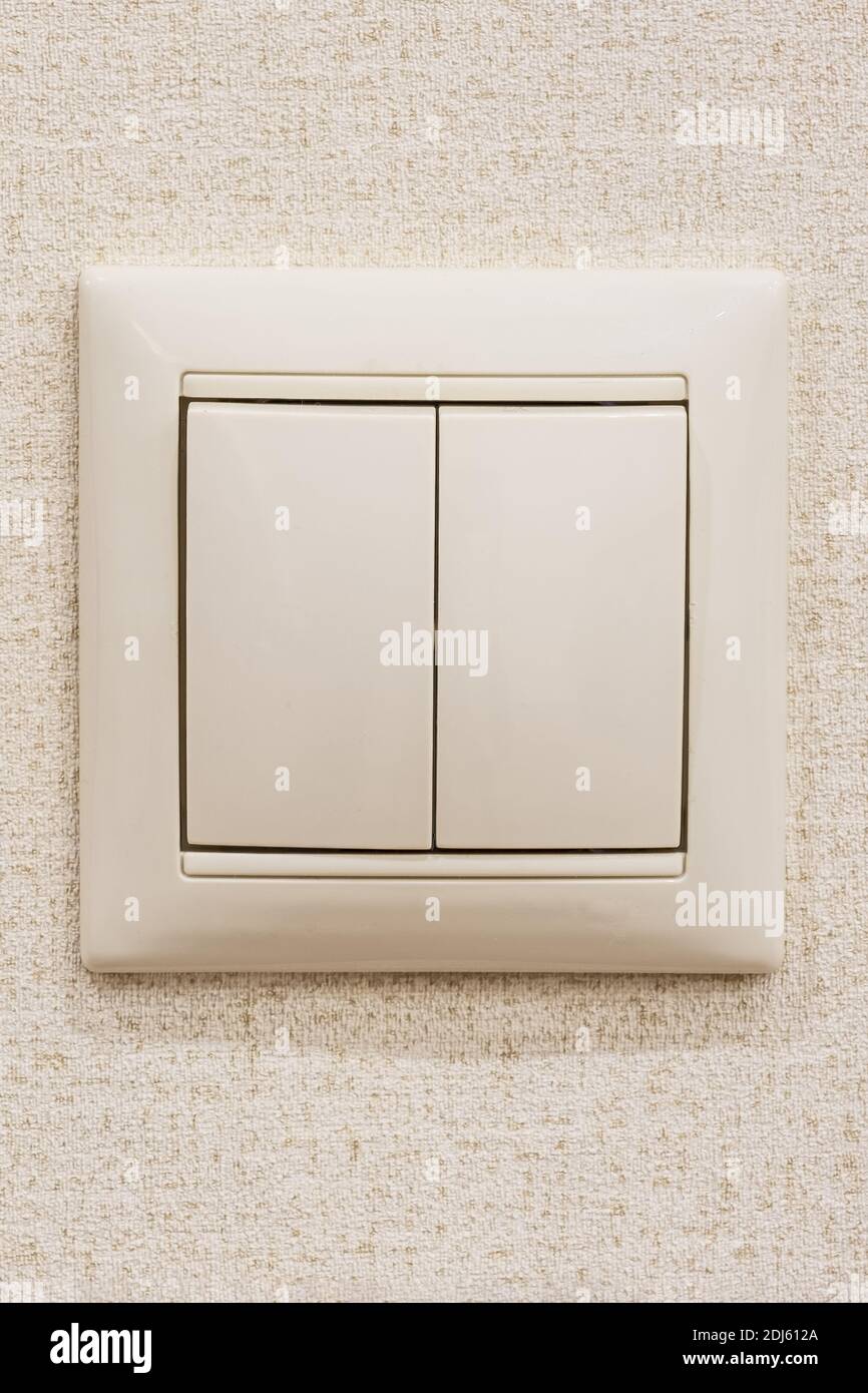 Double switch on beige wall with wallpaper, close-up Stock Photo - Alamy