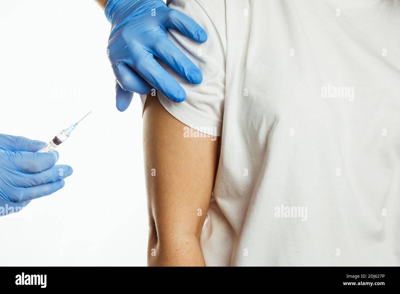 making injection of vaccine in shoulder white background copy space ...