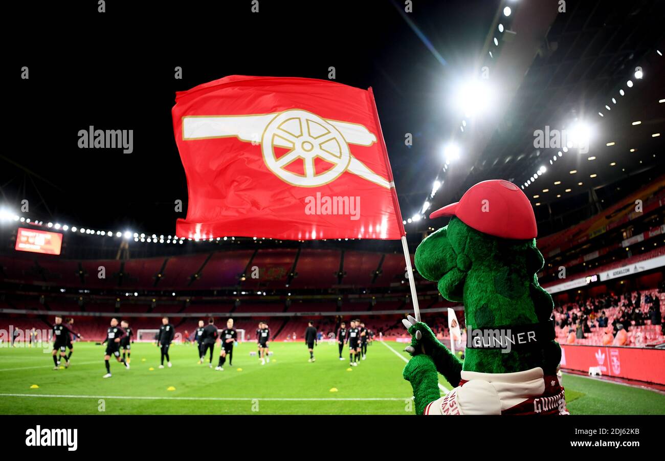 Arsenal mascot Gunnersaurus waves a giant flag as Burnley players warm ...