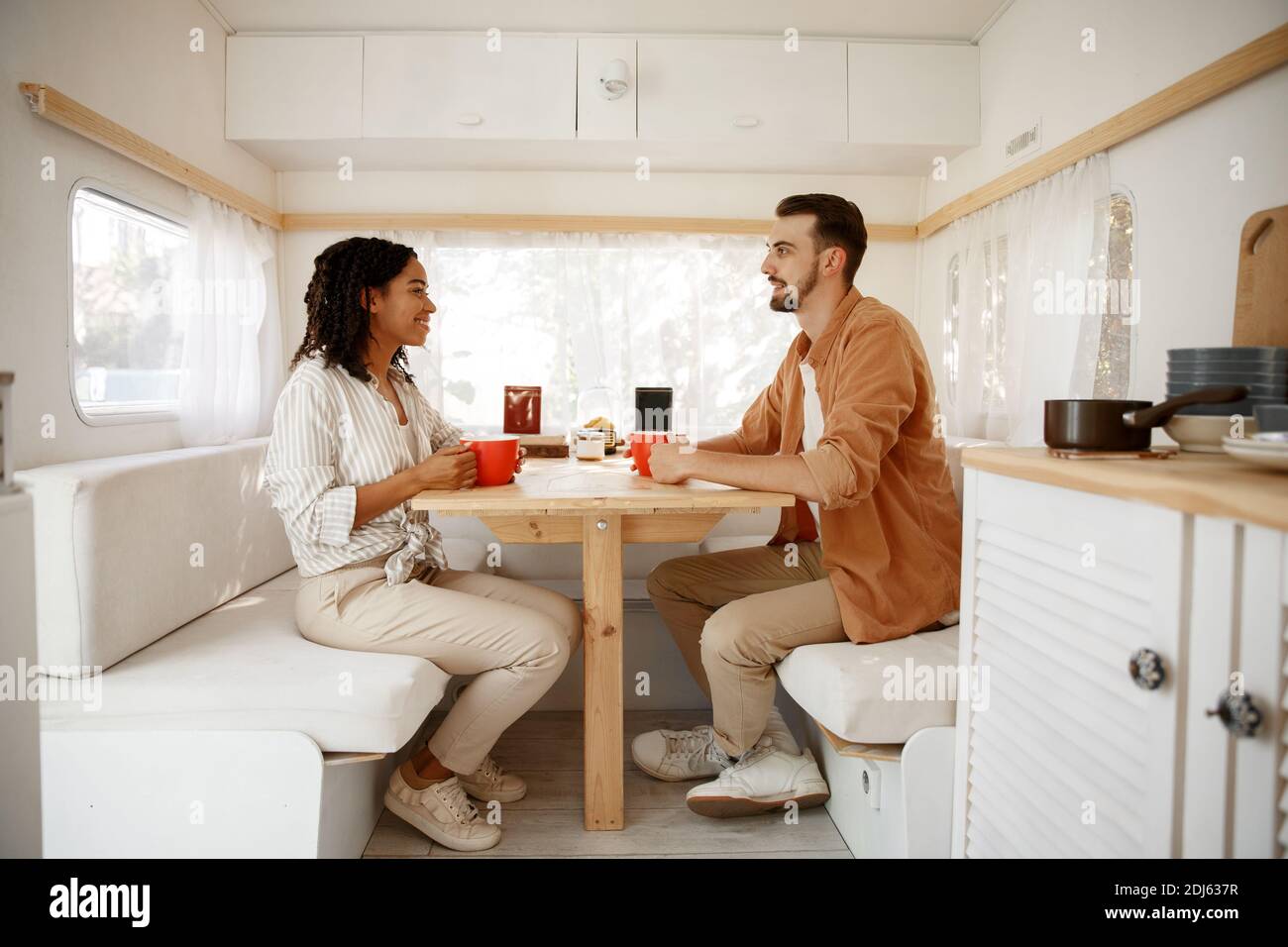 Love couple having breakfast in rv, camping Stock Photo - Alamy