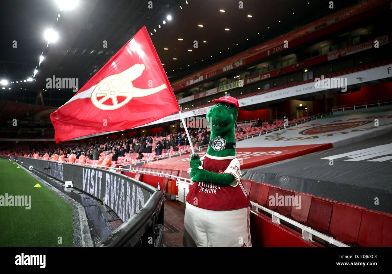 Arsenal mascot Gunnersaurus waves a flag as the players warm up before ...