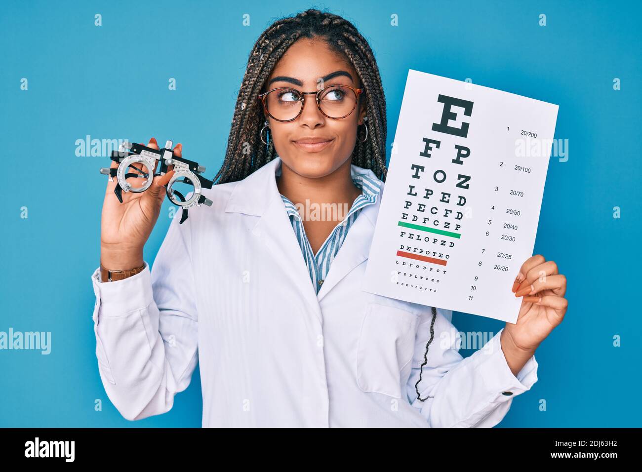 Young african american optician woman with braids holding optometry ...