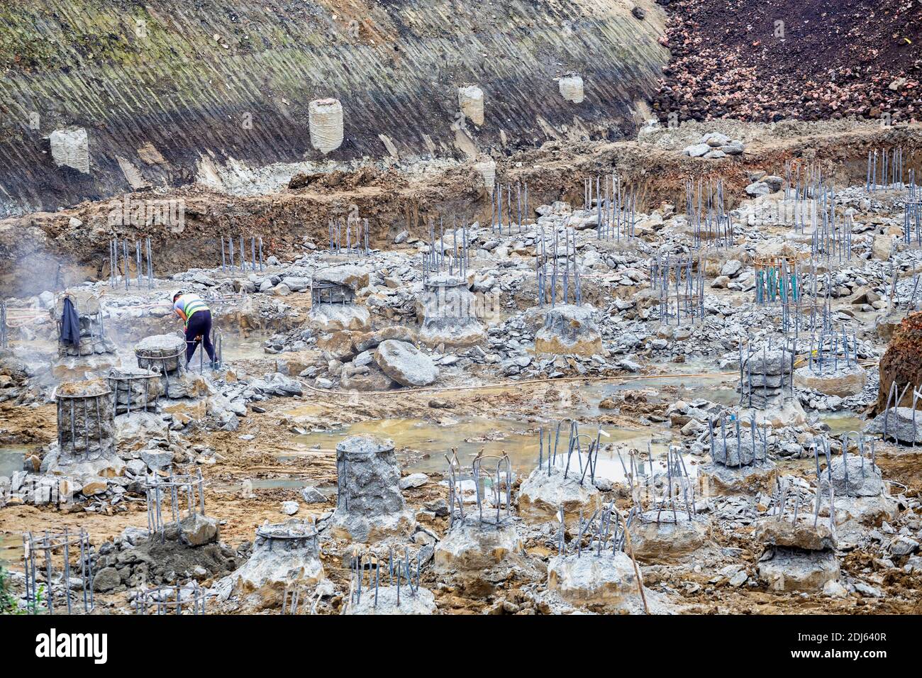 Crushed concrete round piles and reinforcing bar at construction site ...