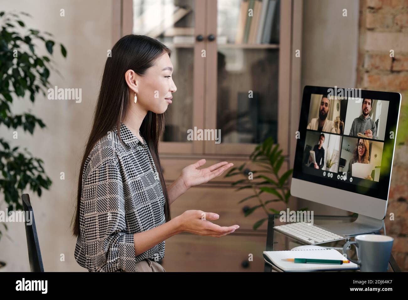 Confident and smiling young female office manager with long dark hair ...