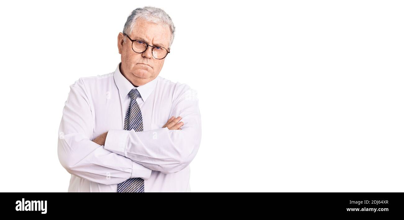 Senior grey-haired man wearing business clothes skeptic and nervous ...