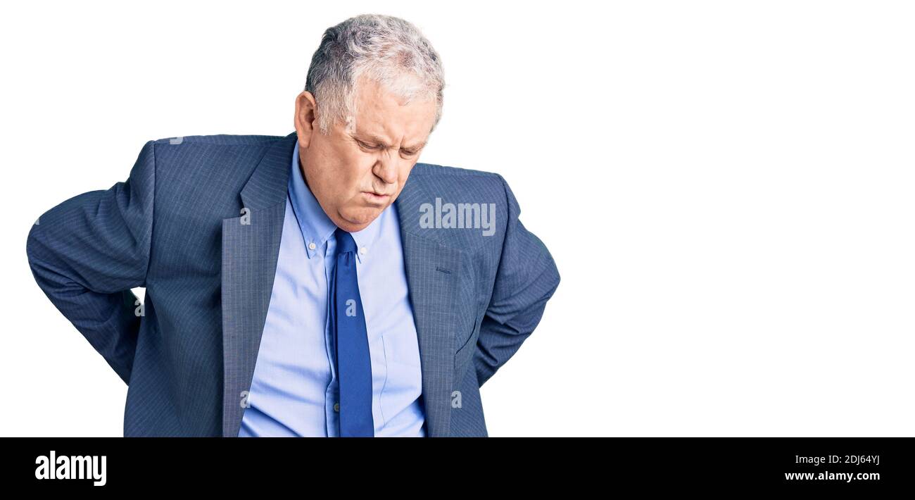 Senior grey-haired man wearing business jacket suffering of backache ...